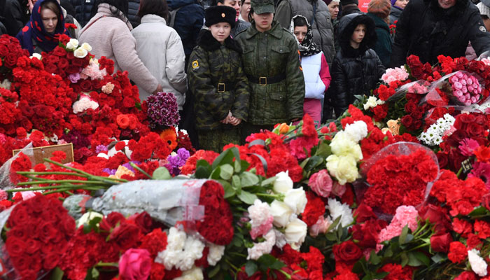 Russians lower flags, lay flowers to honour concert hall attack victims