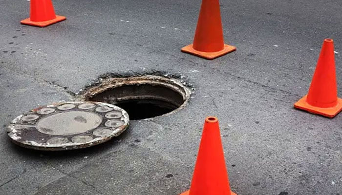 Two of five children die after falling into manhole
